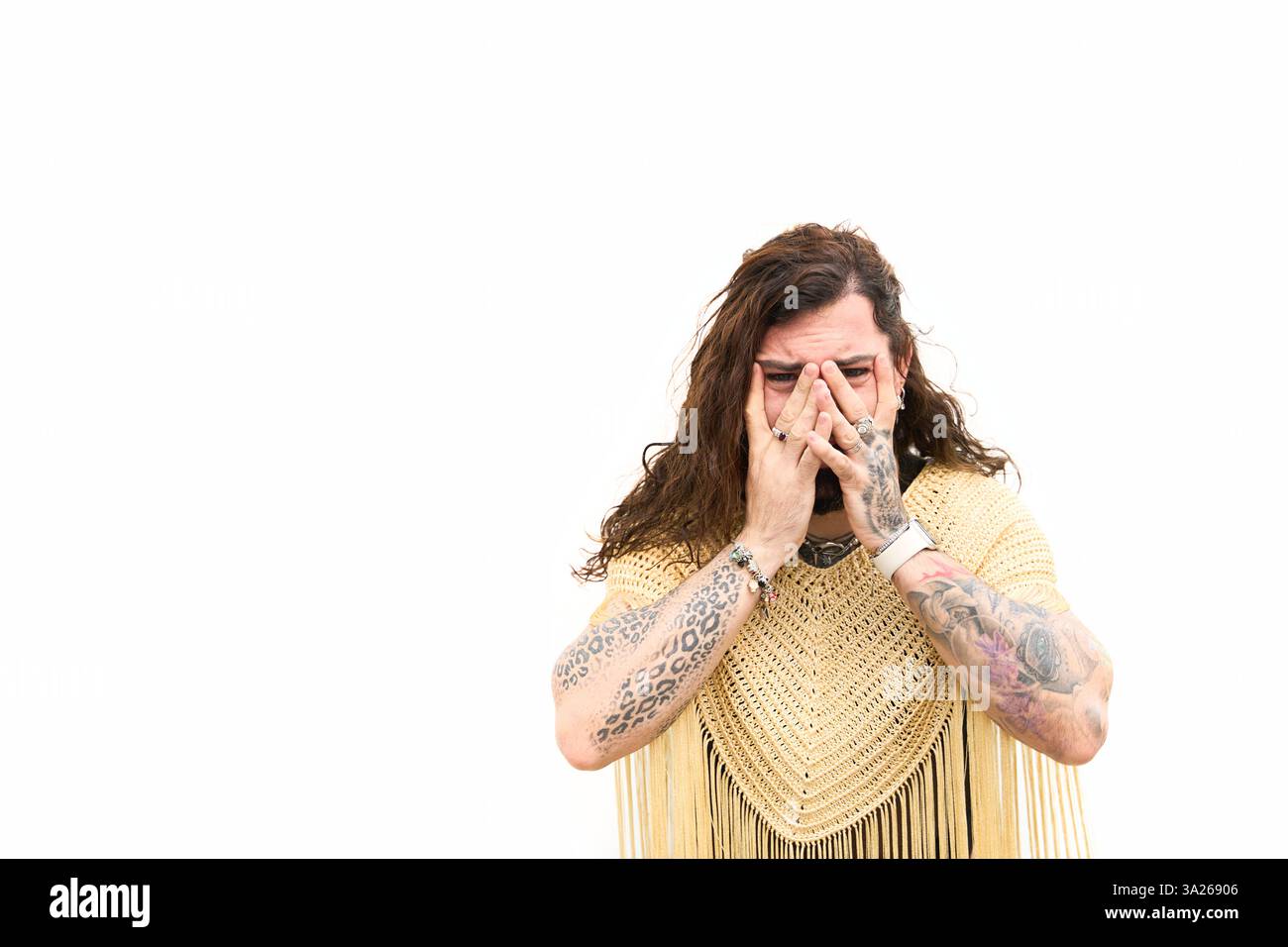 Portrait of a transgender latin person with long hair, beard and ...