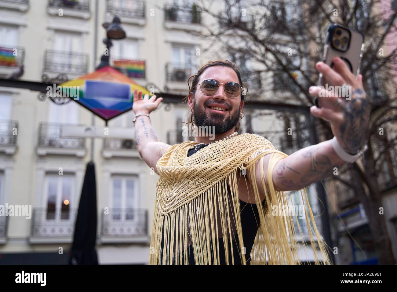 Happy non binary person with long hair and beard taking a selfie with ...