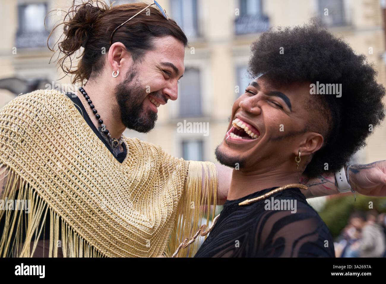 Two men, expressing their love and happiness, laugh together in a ...