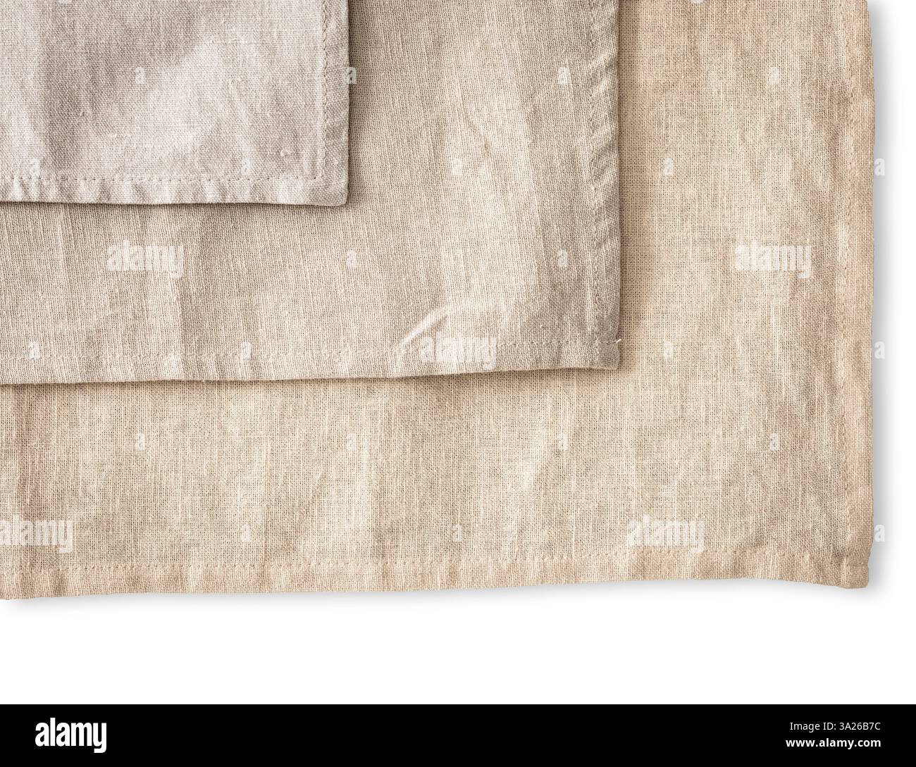 Soft linen and cotton textiles in neutral tones are carefully arranged ...