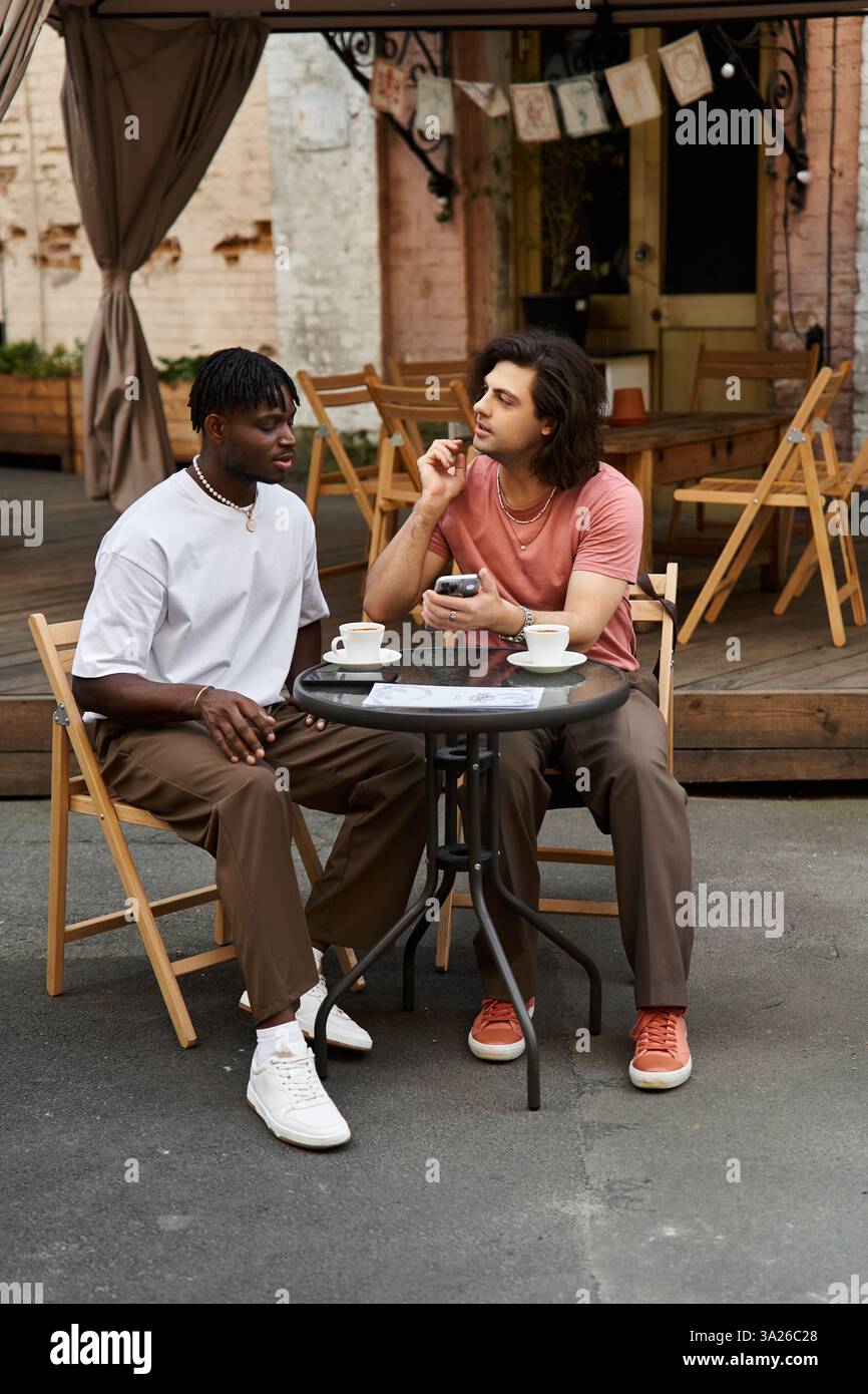 Two handsome men enjoy an intimate conversation over coffee at a cozy ...