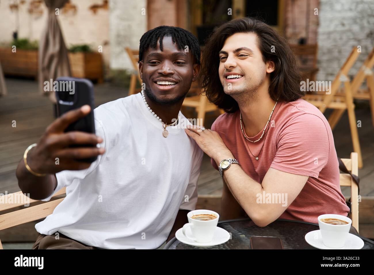 Two handsome men share a joyful experience as they take a selfie on a ...