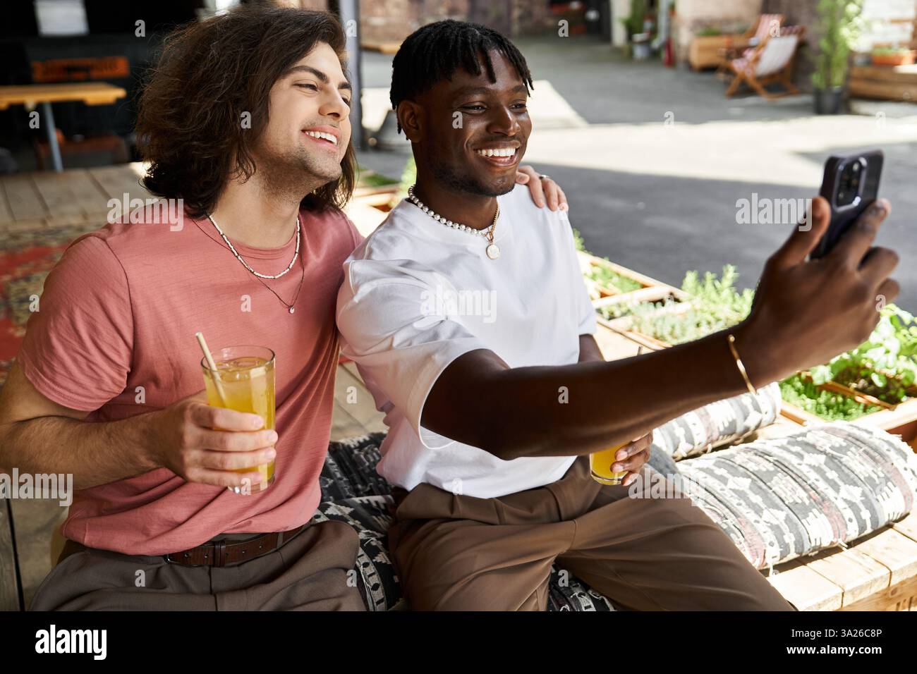 Two attractive people laugh and toast while snapping a selfie on a ...