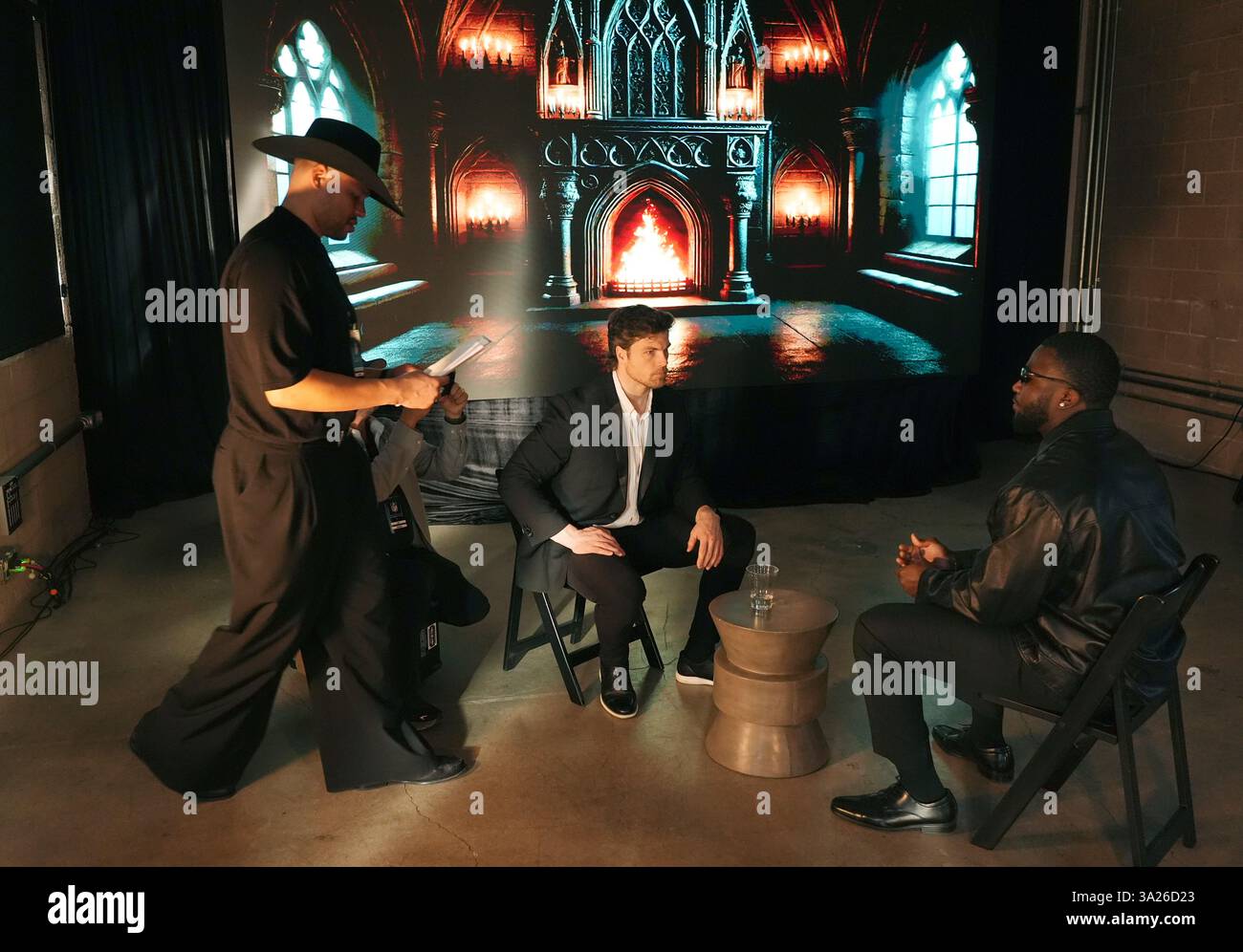 Retired NFL linebacker Brennan Scarlett, left, directs actor and ...