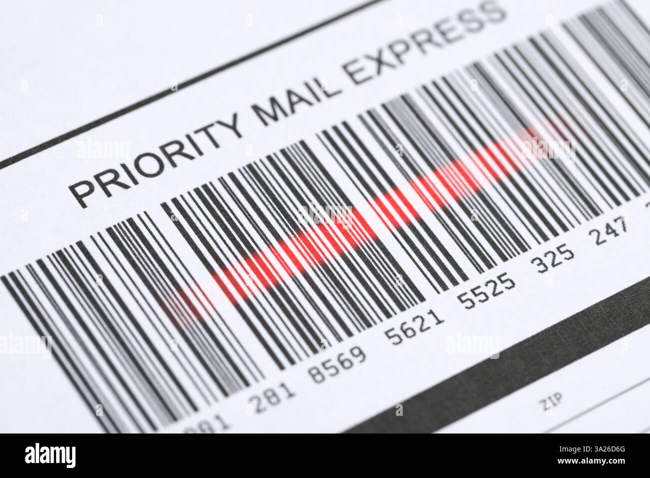 Parcel with label, closeup. Red laser light on barcode for scanning ...