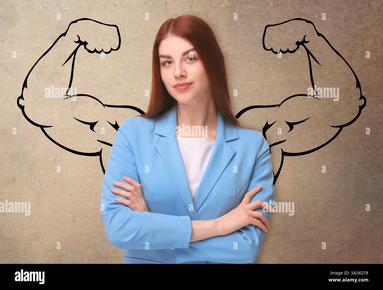 Confident woman with drawing of strong arms behind her on beige ...