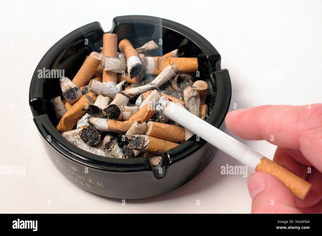 the smoking of a cigarette and an ashtray, nicotine addiction the ...