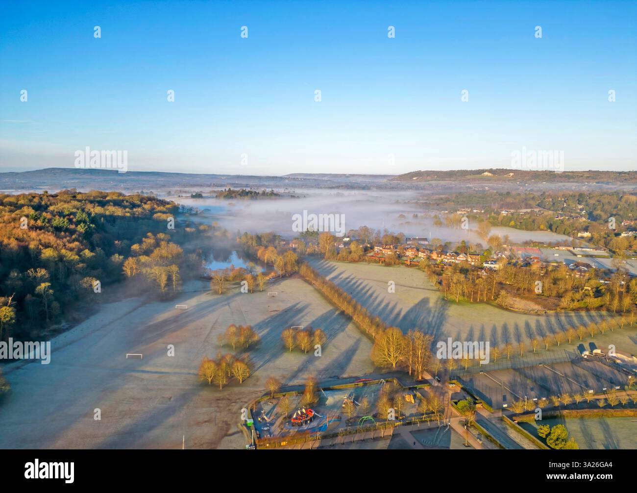aerial view of low mist at reigate priory park on a cold and frosty ...