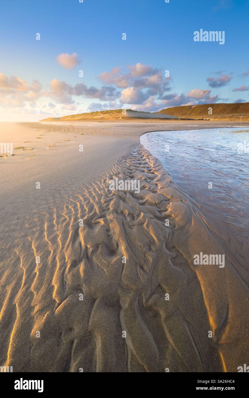 The beach at Hargen aan Zee at low tide with a beautiful sunset. The ...