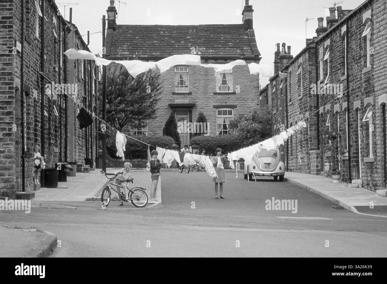 Washing hanging on line across street and children playing out in the ...