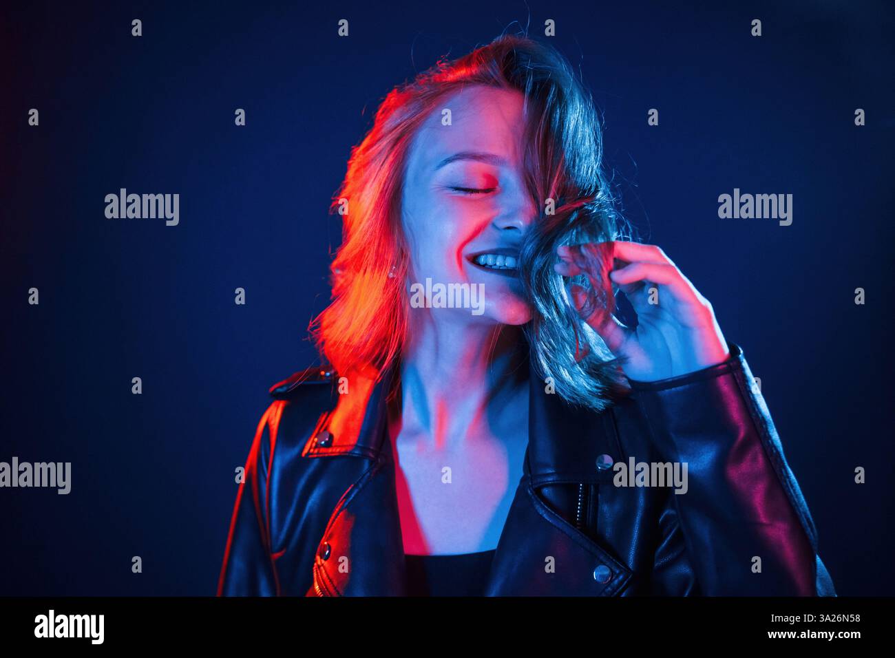 Positive facial expression. Cool young woman portrait in neon colors ...