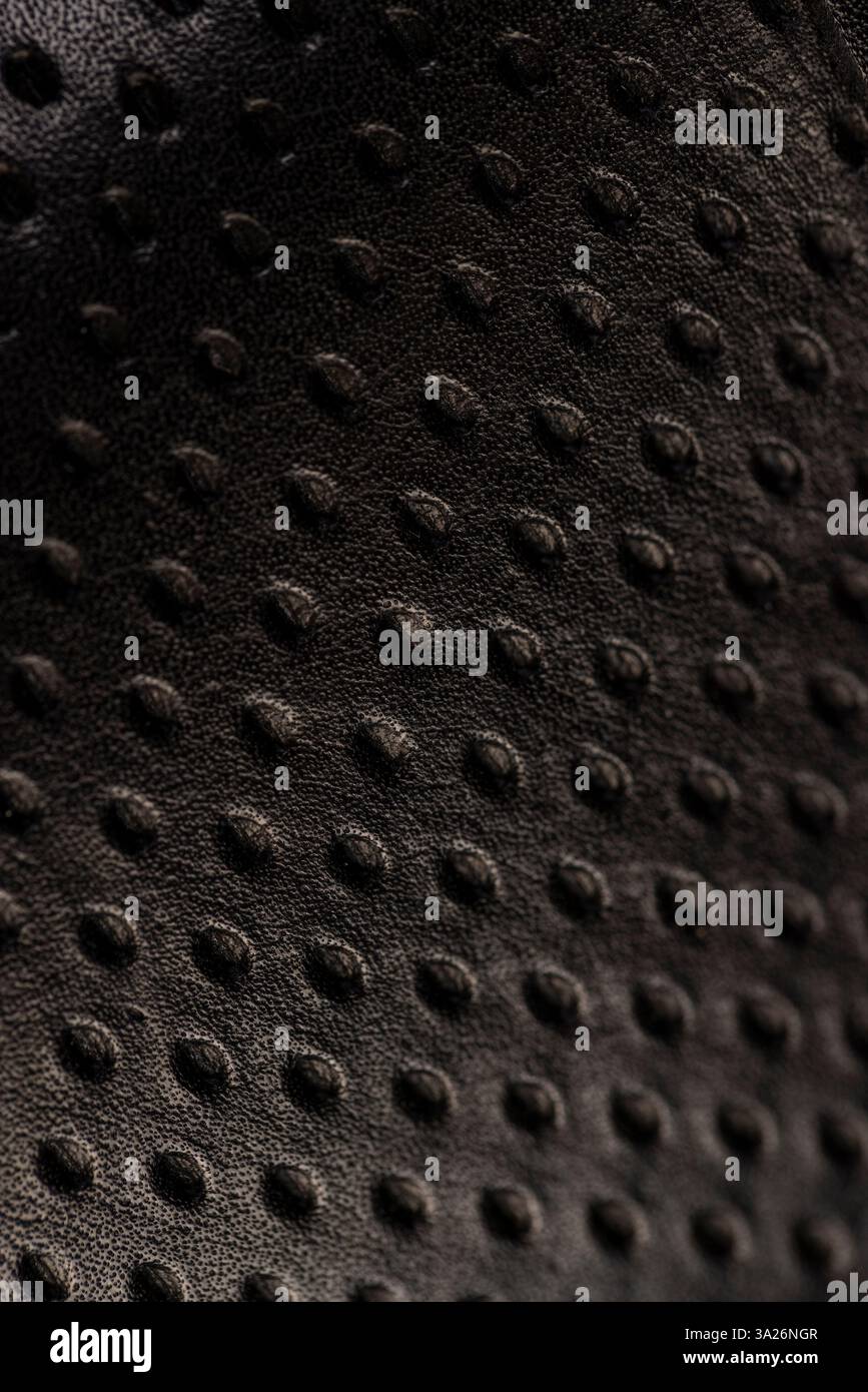 leather perforated with holes closeup, painted black, details of a ...
