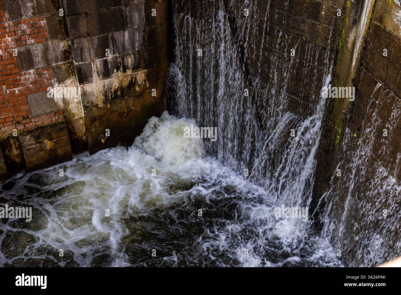 wooden dam with a lot of holes, old wooden fences with leaking water in ...