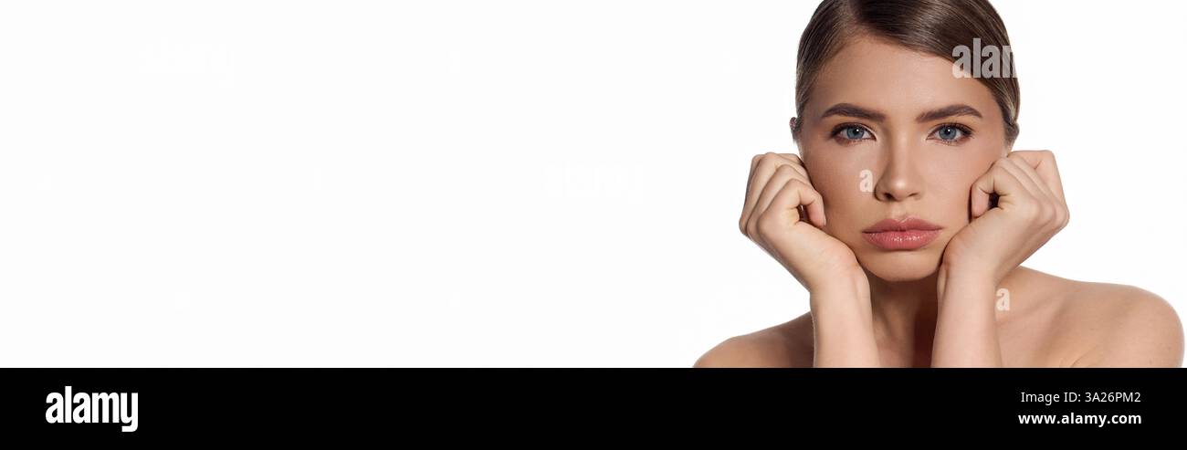 Stylish and beautiful young woman shows off her elegance with a serene ...