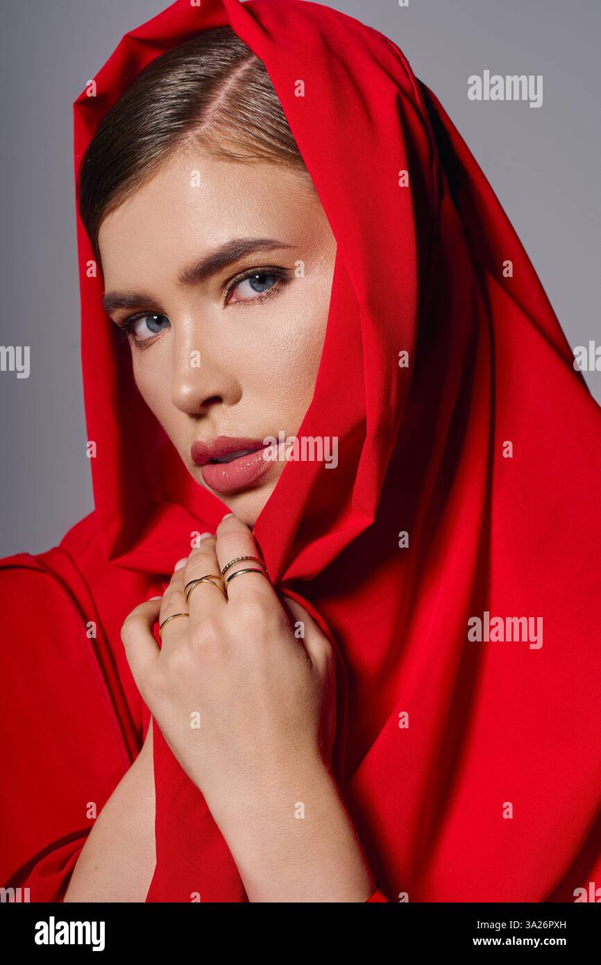 A young woman with a red headscarf captivates all with her elegance ...
