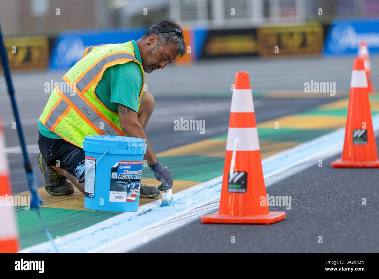 MELBOURNE, AUSTRALIA - MARCH 12: A staff works on painting the kerb ...
