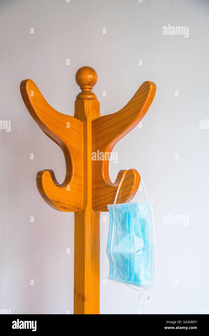 Mask hanging on a coat stand Stock Photo - Alamy