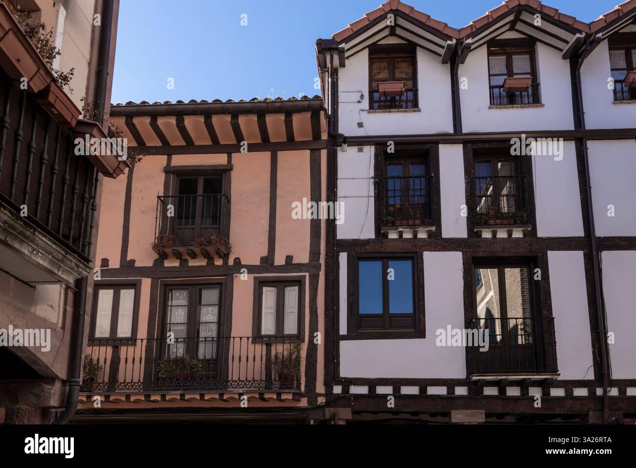Two traditional half-timbered buildings with wooden balconies and ...