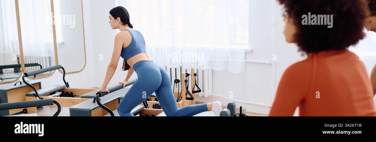 Two people engage in a pilates session, building strength and ...