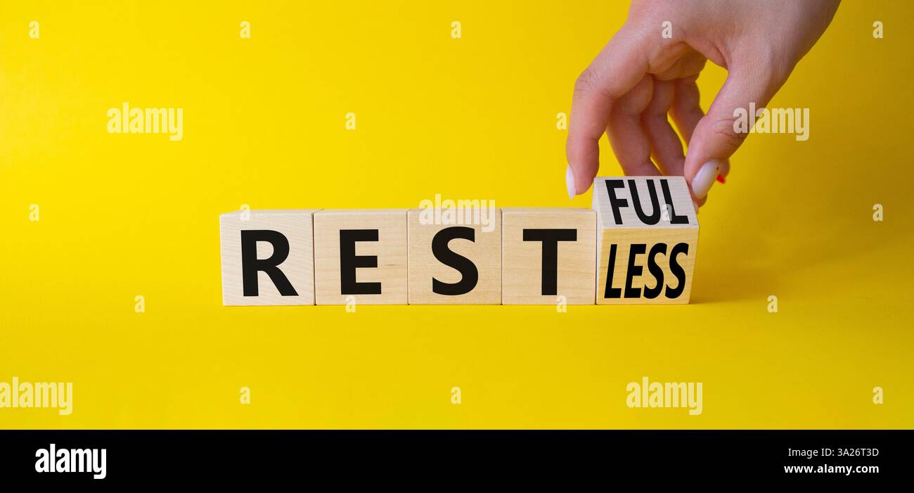 Restful and Restless symbol. Businessman hand turnes wooden cubes and ...