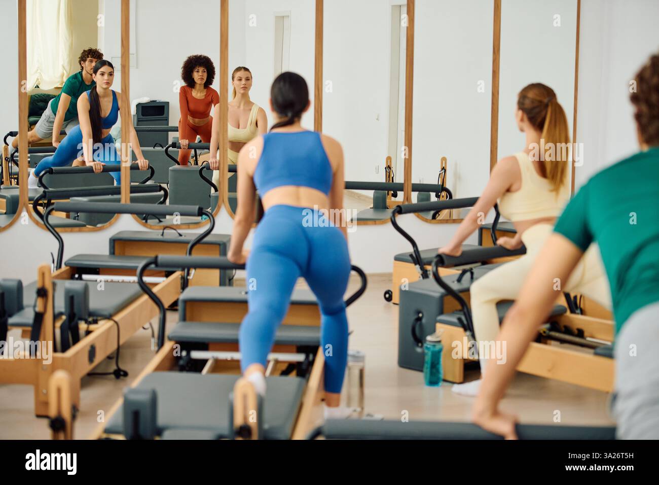 Participants engage in an interactive Pilates session, showcasing ...