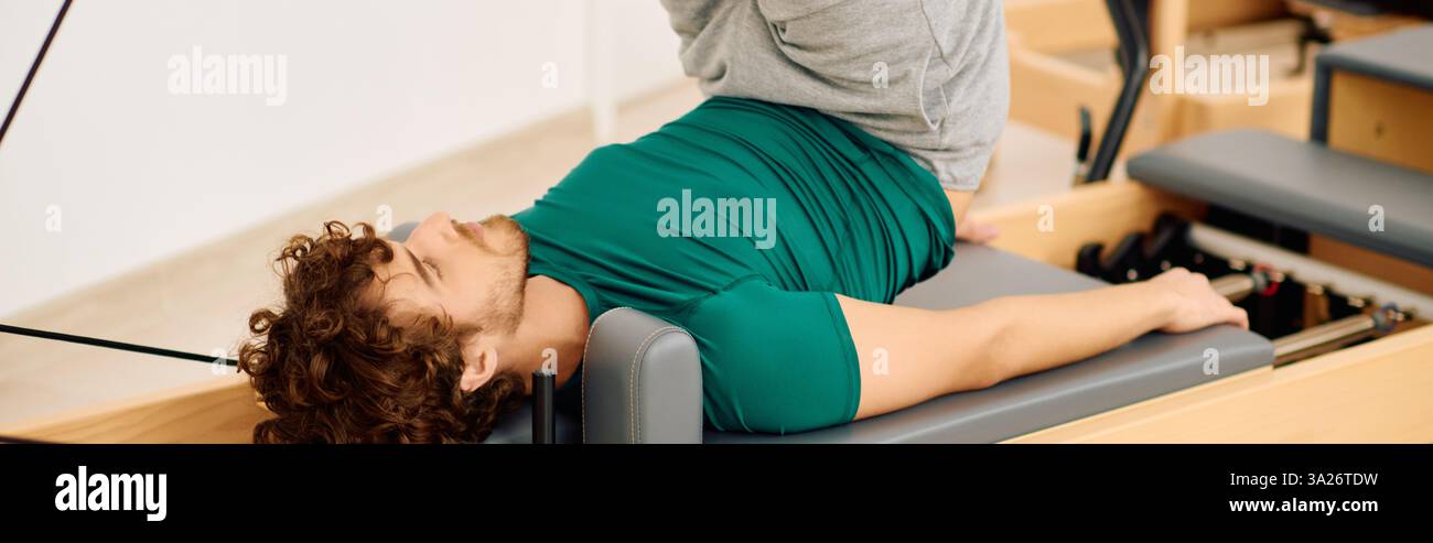 A focused person practices a challenging pilates move in an airy studio ...