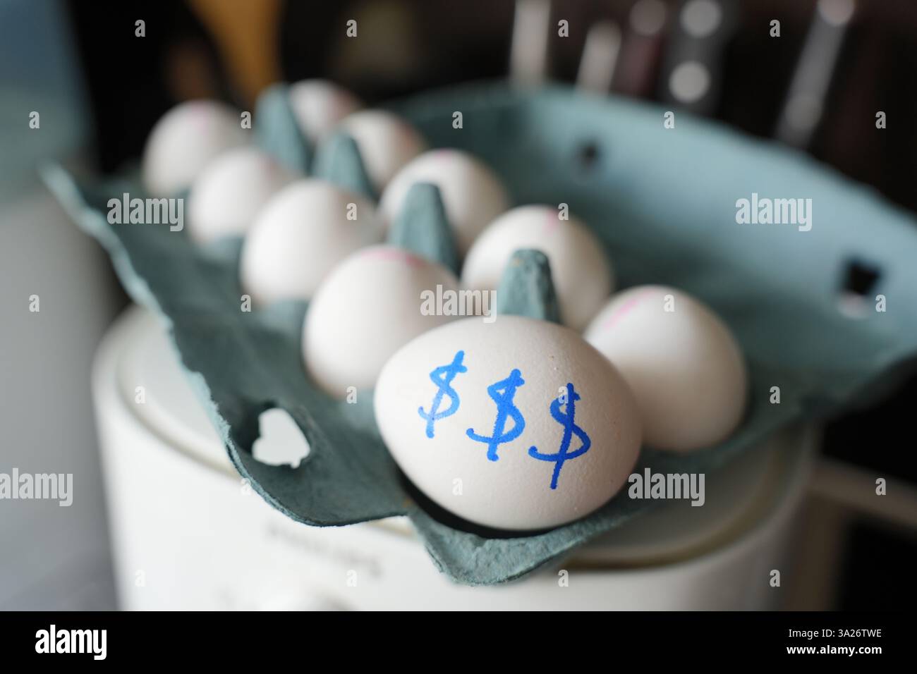 Box of white eggs with one egg marked with dollar signs, depicting high ...