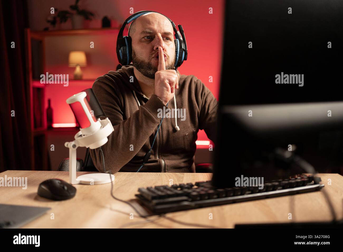 Gamer streamer playing online game on PC in dark room. Placing finger ...