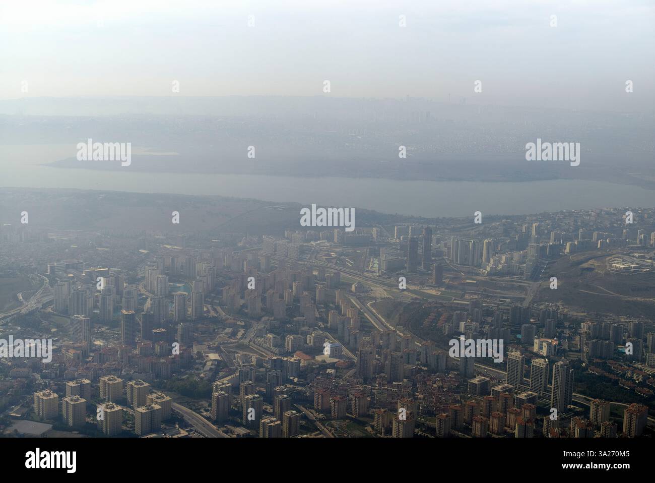 Aerial view of a vast urban cityscape with high-rise buildings and a ...