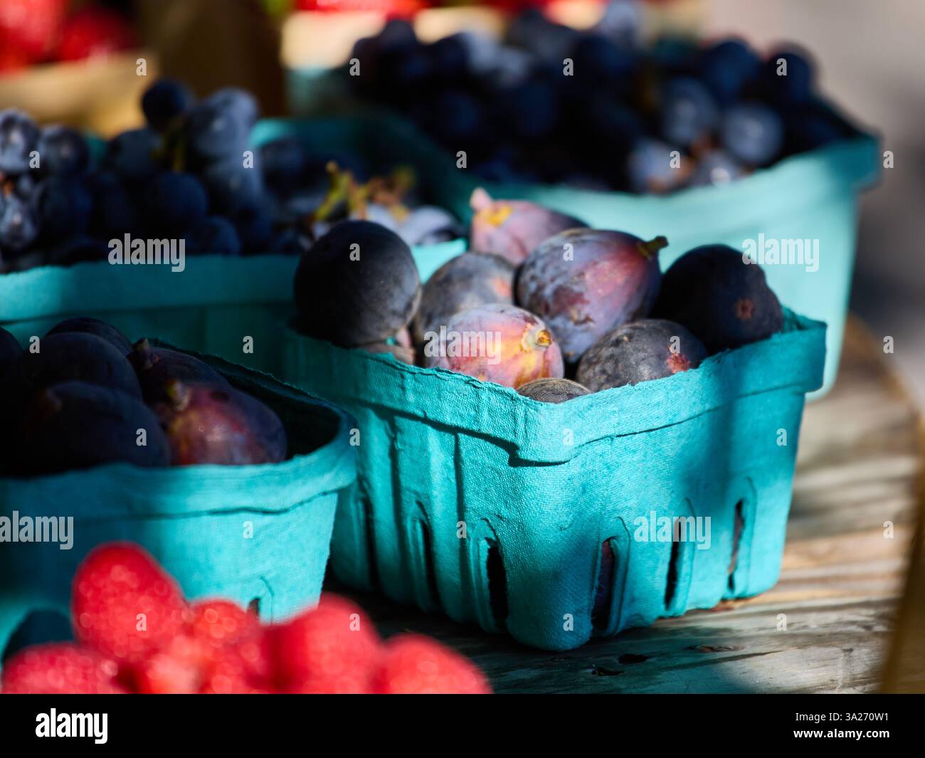 plums in a blue box Stock Photo - Alamy