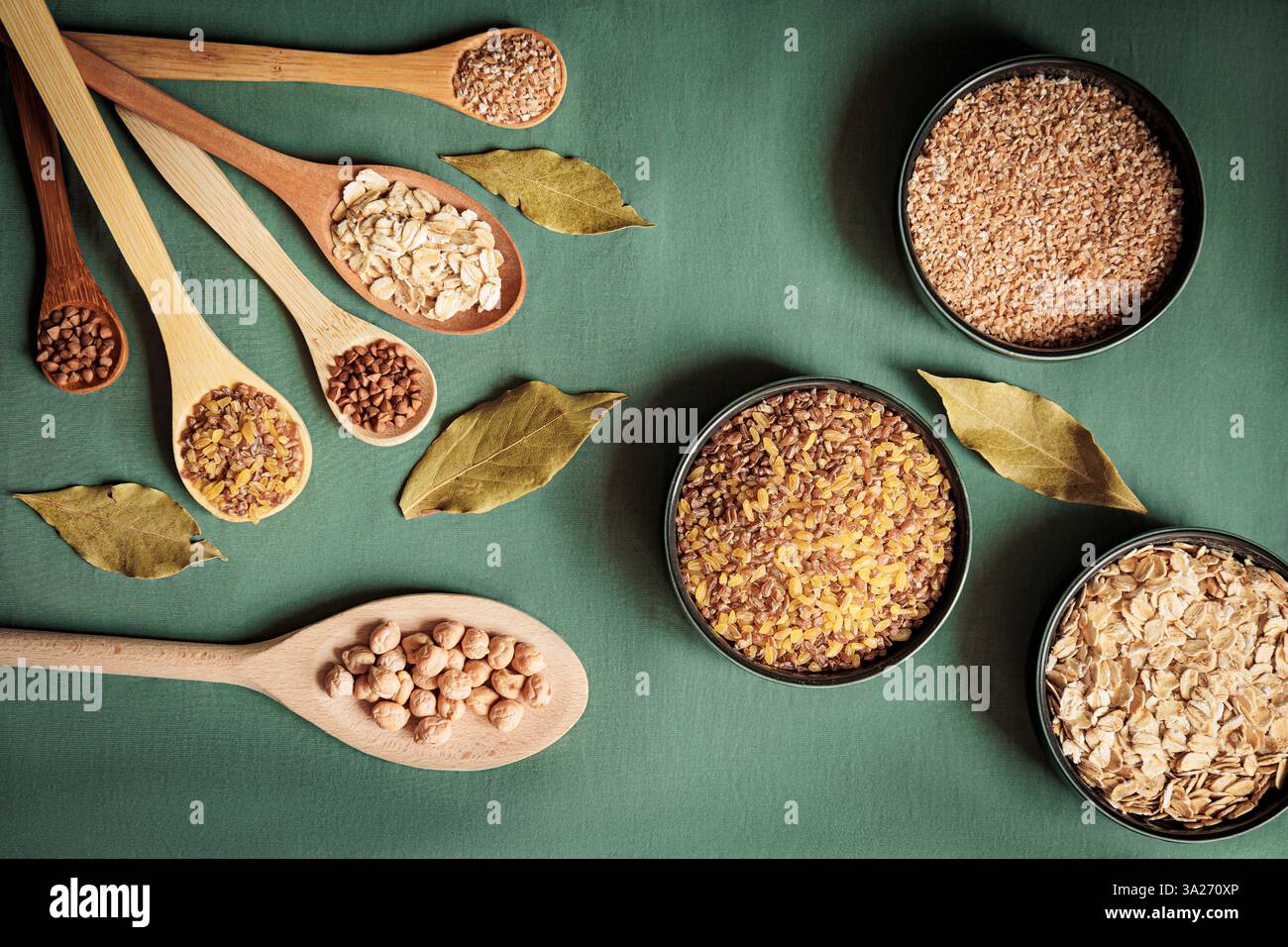 Wooden spoons with grains, chickpeas, and cereals arranged next to ...