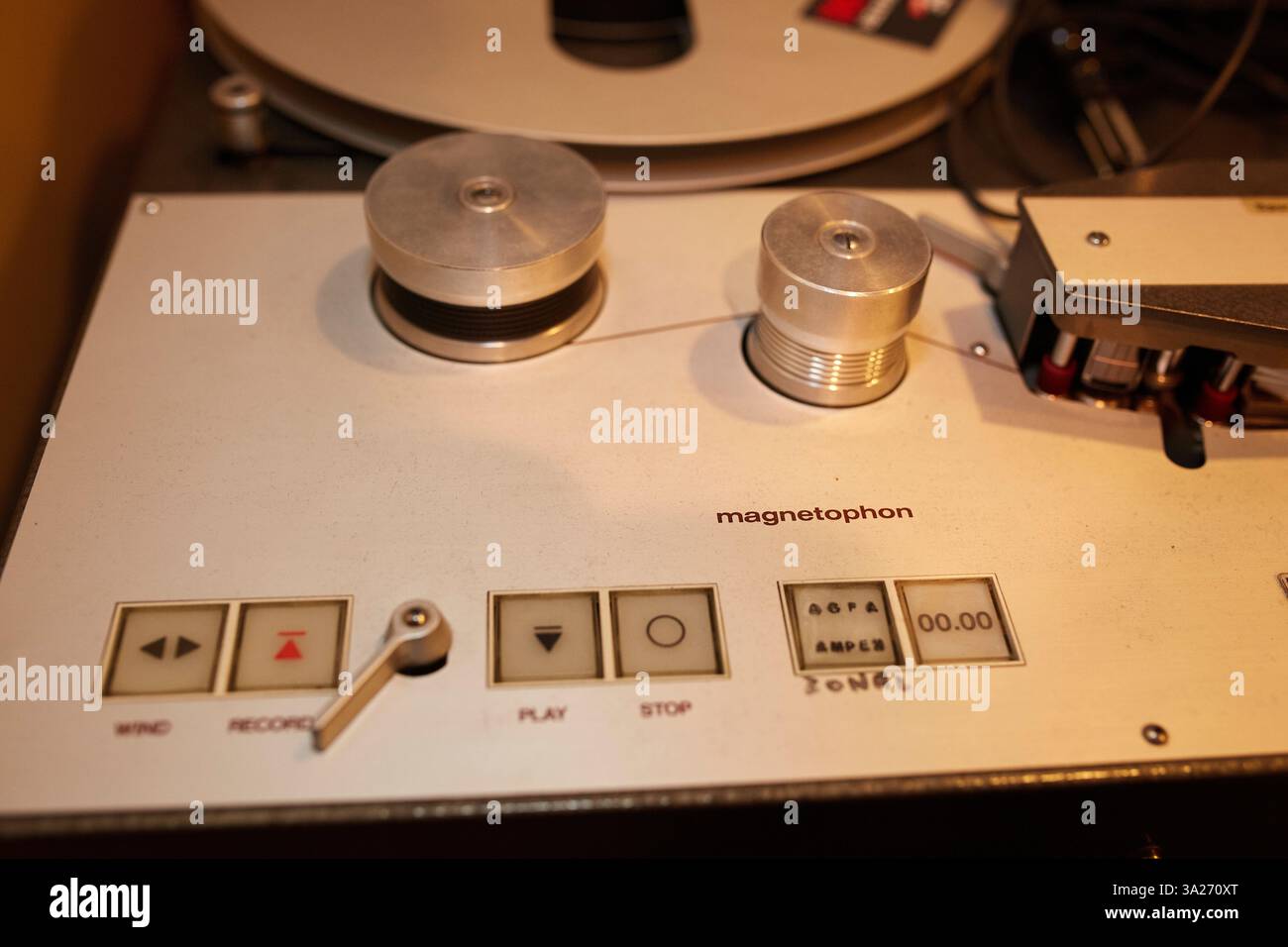 Vintage reel-to-reel tape recorder with buttons and large reels on ...