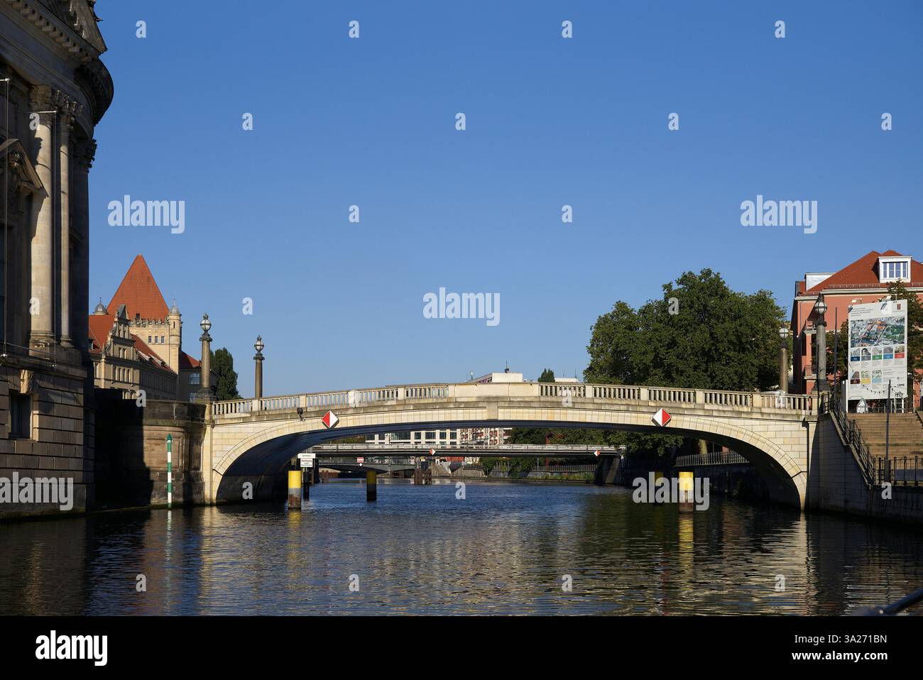 Elegant stone bridge over a calm river with historic buildings and ...