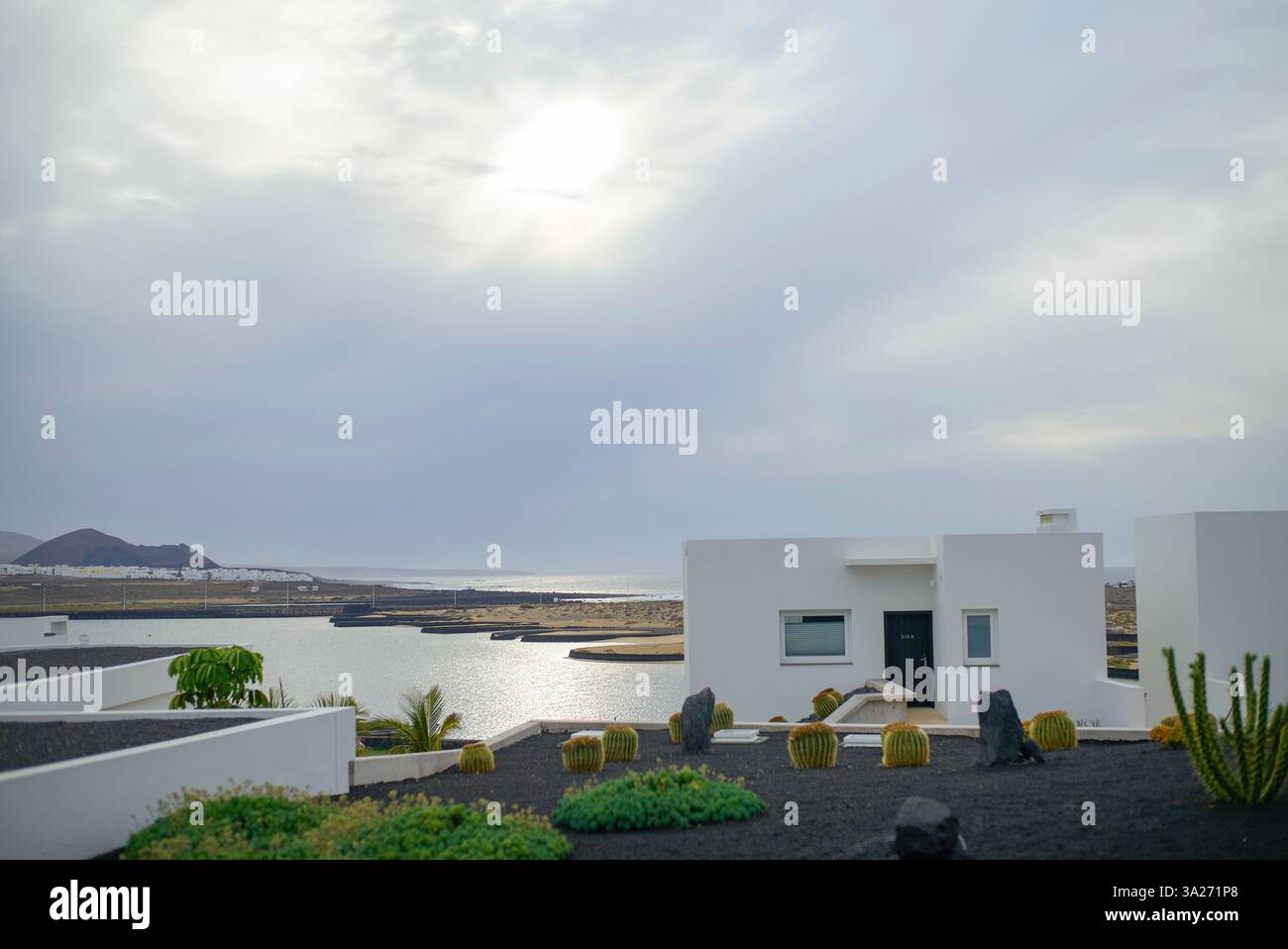Modern white house with geometric design in arid landscape under a ...
