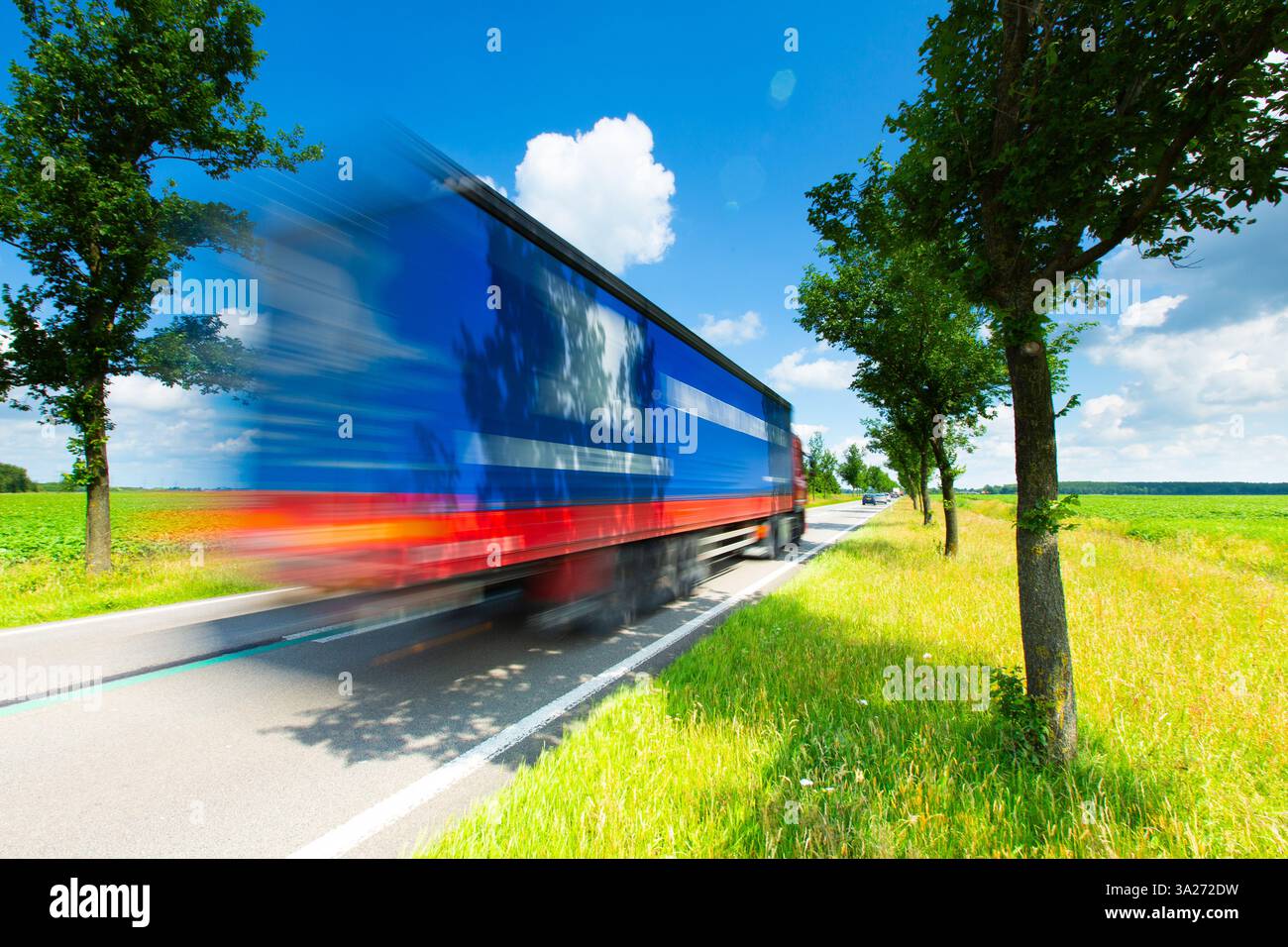 Trucks in motion driving on the highway at speed transporting cargo - a ...