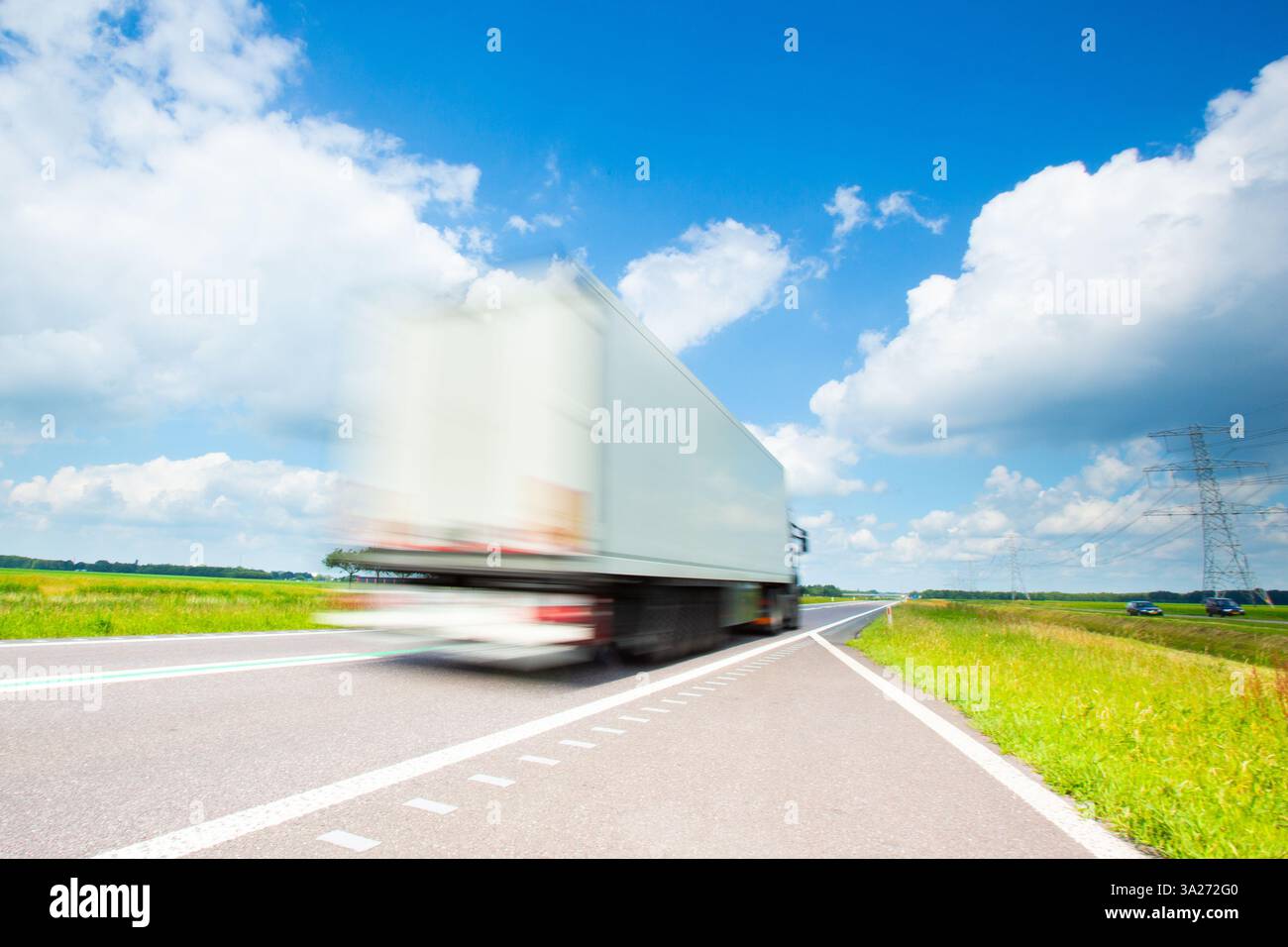 Trucks in motion driving on the highway at speed transporting cargo - a ...