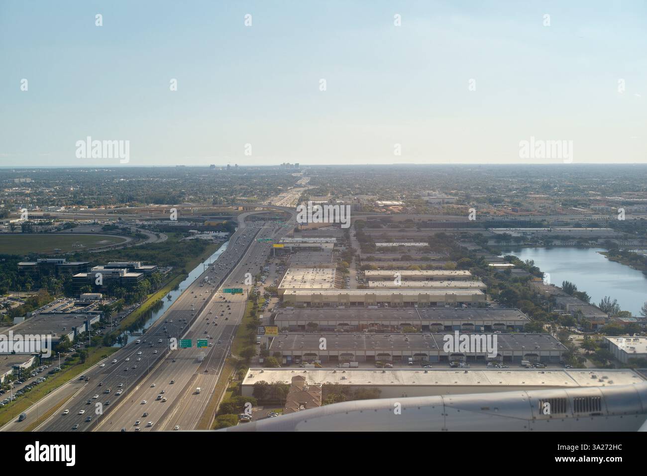 Aerial view from a landing plane of a sprawling urban area with ...