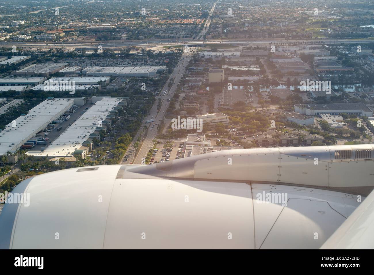 Aerial cityscape from a landing plane window showing buildings, roads ...