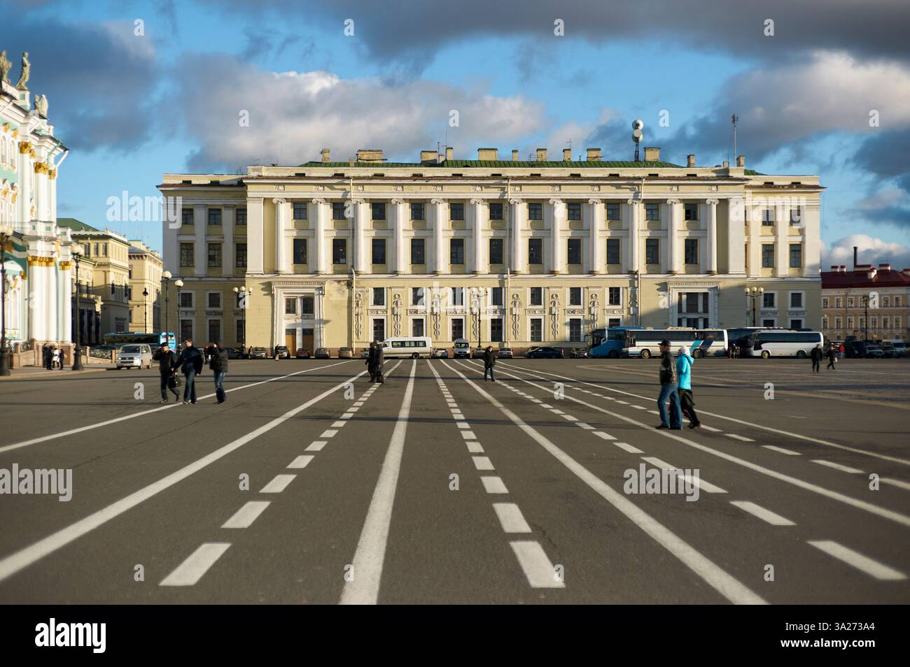 Wide open city square with people walking on lined pavement and ...