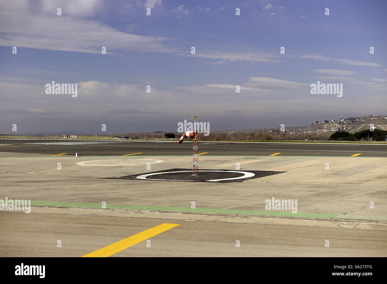 Empty airport runway with a windsock under a partly cloudy sky. Gran Canary, Spain Stock Photo ...
