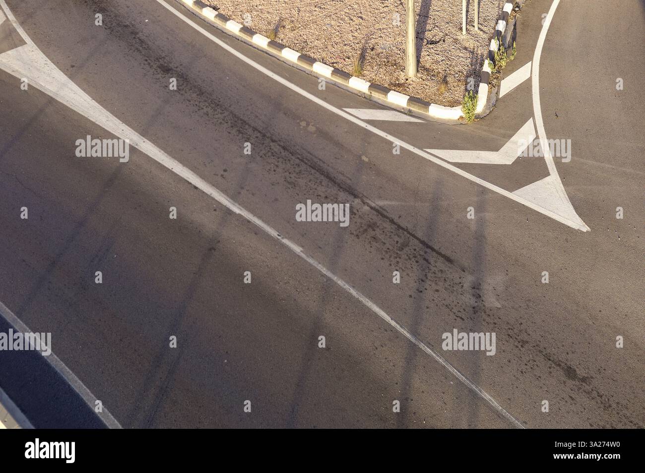Aerial view of an empty asphalt road intersection with white road ...