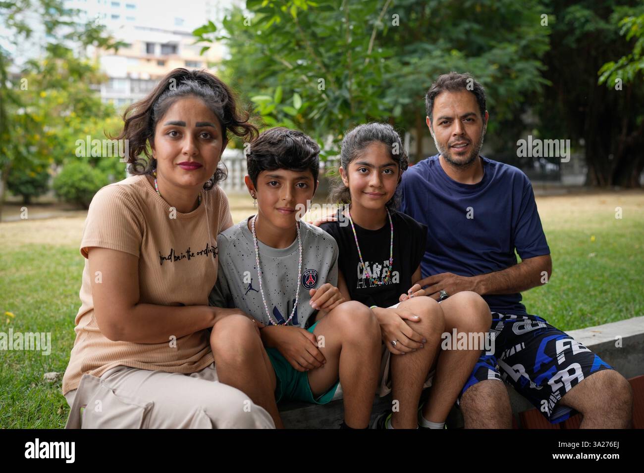 Ebrahim Ghezelgechi, right, a migrant from Iran, poses for a portrait ...
