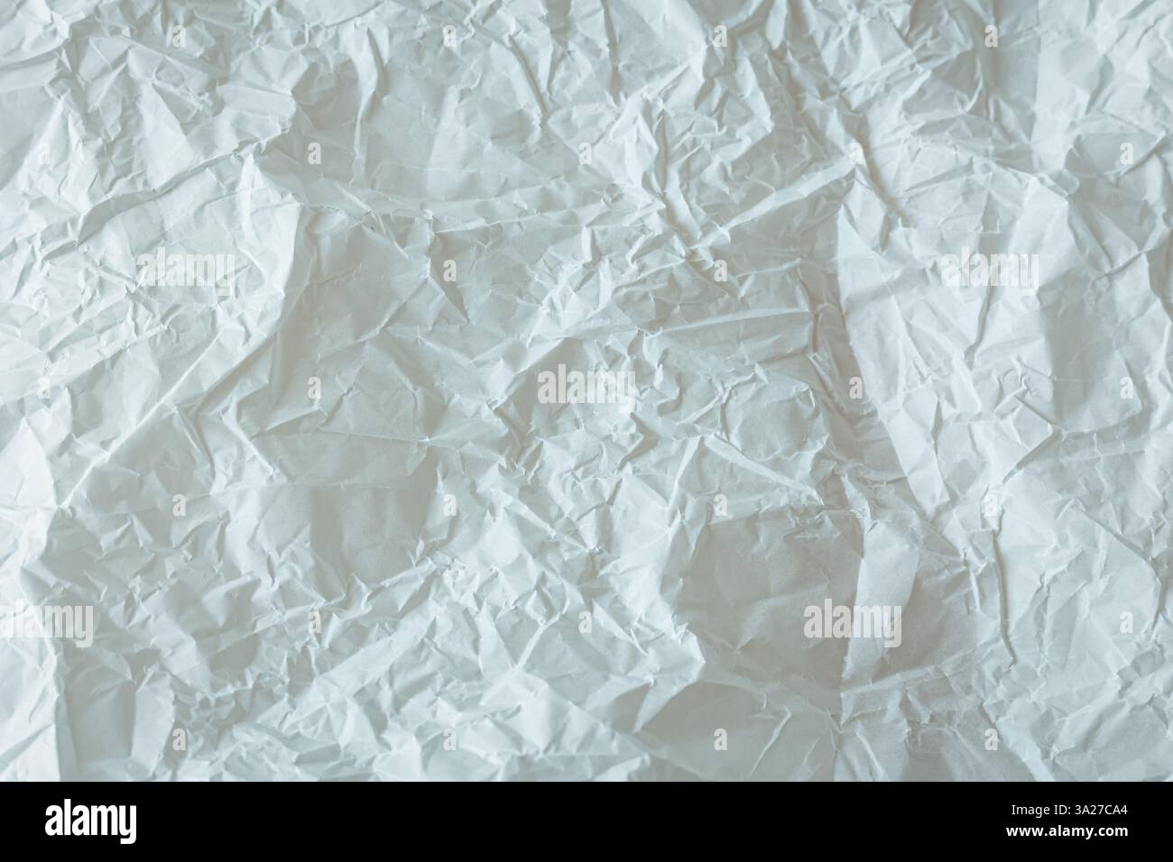Close-up of crumpled white paper texture with soft natural lighting ...