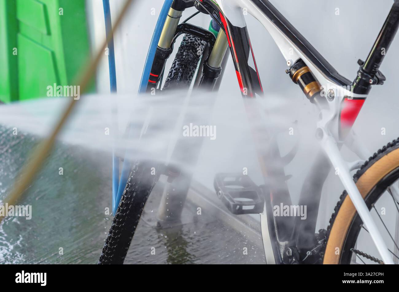 White frame bike with water jet on green backdrop Stock Photo - Alamy