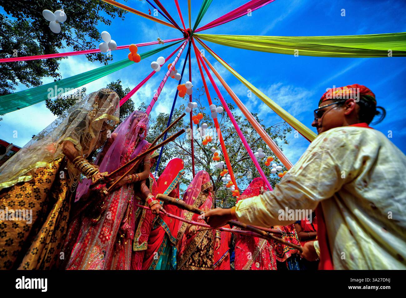 Mathura, India. 11th Mar, 2025. Hindu devotees are seen playing with ...