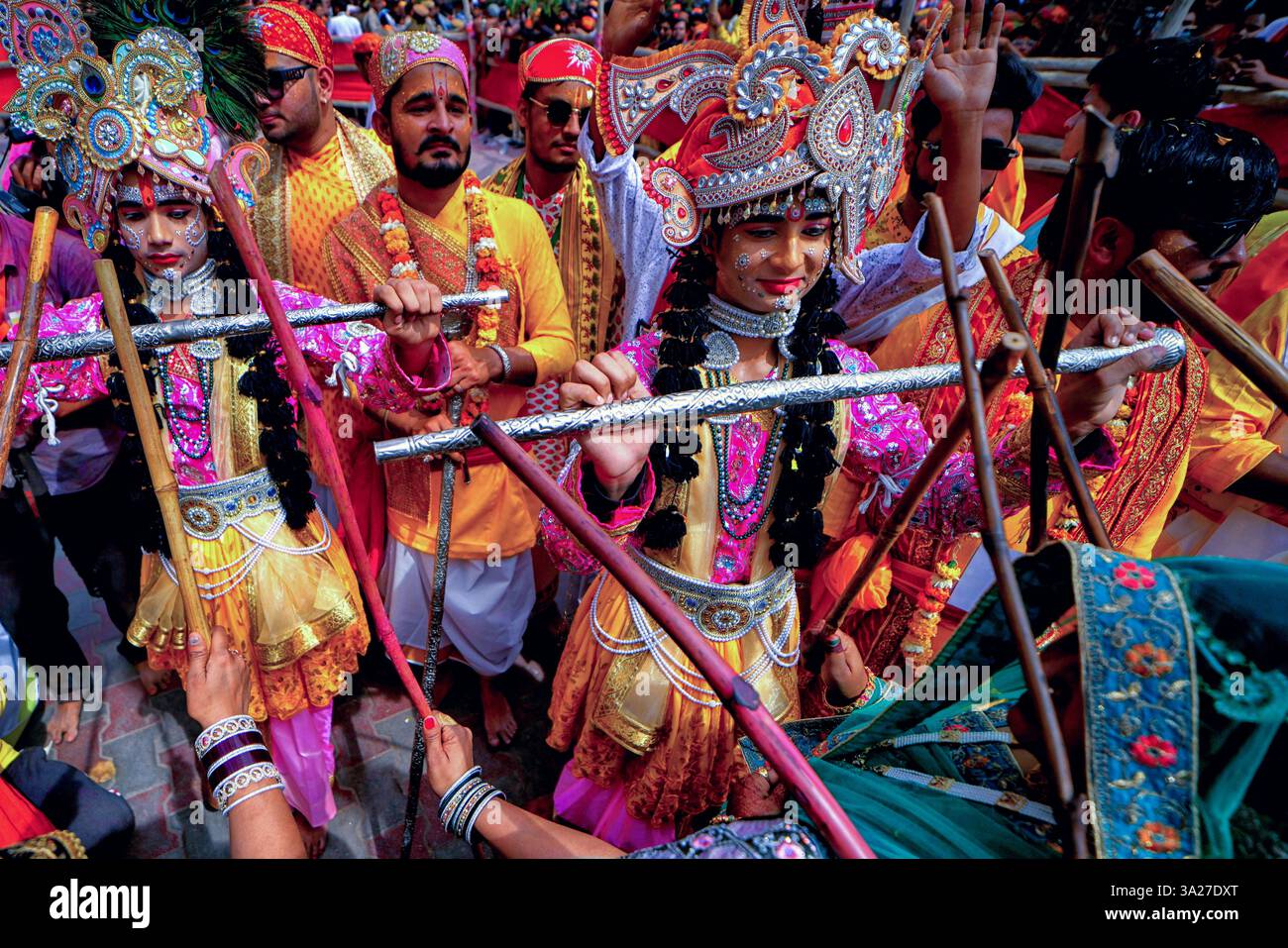 Mathura, India. 11th Mar, 2025. Hindu devotees are seen playing with ...
