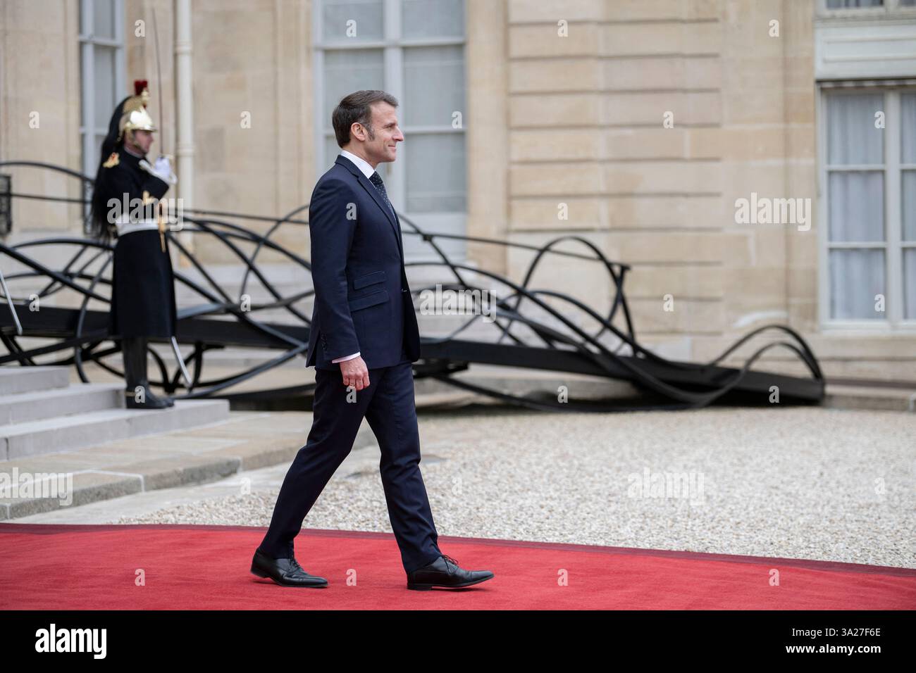 France's President Emmanuel Macron walks alone at Elysee Palace in ...