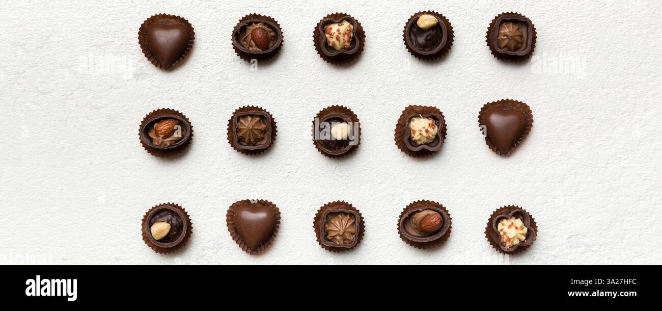 Different kinds of chocolates on colored table close-up. Top View and ...