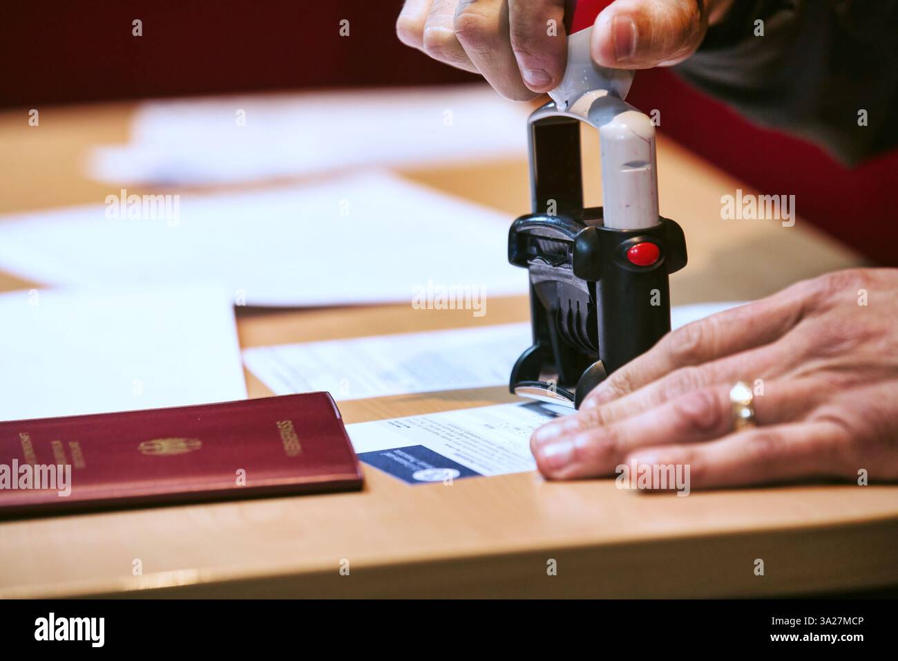 Close-up shot of a white Caucasian person's hand stamping a foreign ...