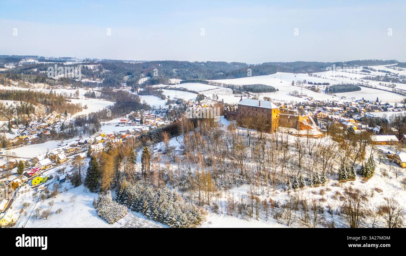 Pecka medieval castle stands majestically atop a snowy hill ...